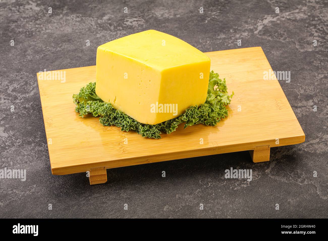 Yellow tilsiter cheese dairy product brick Stock Photo - Alamy