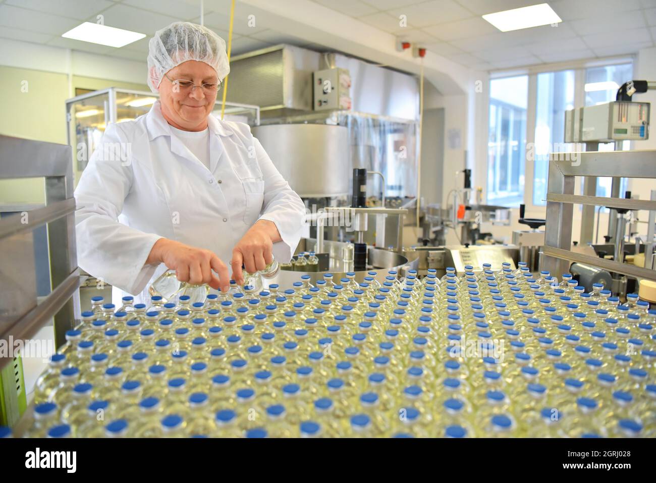 medical products manufacturing in a modern factory - glass bottles with ...