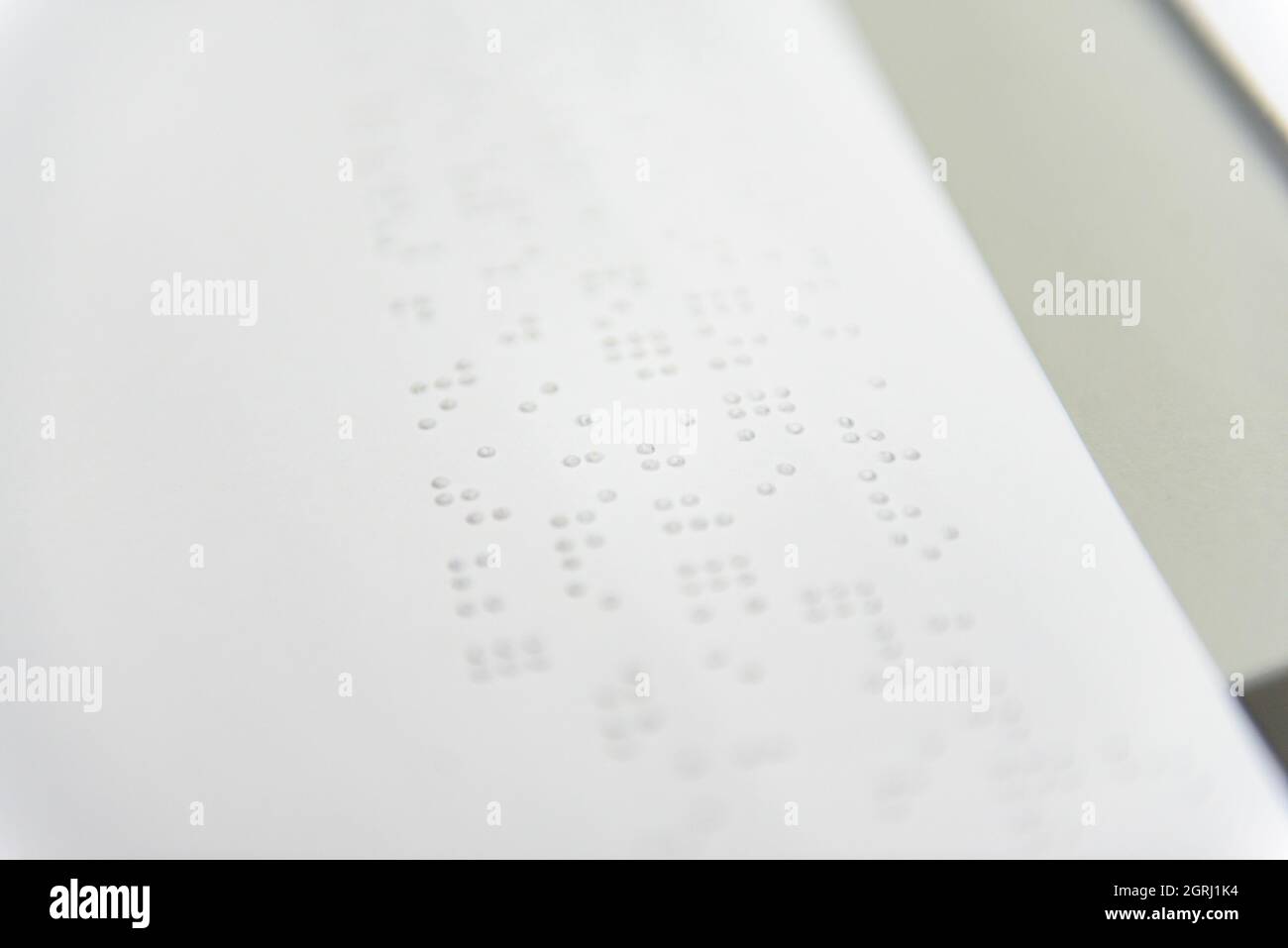 A fragment of text in Louis Braille printed on a standard sheet of ...