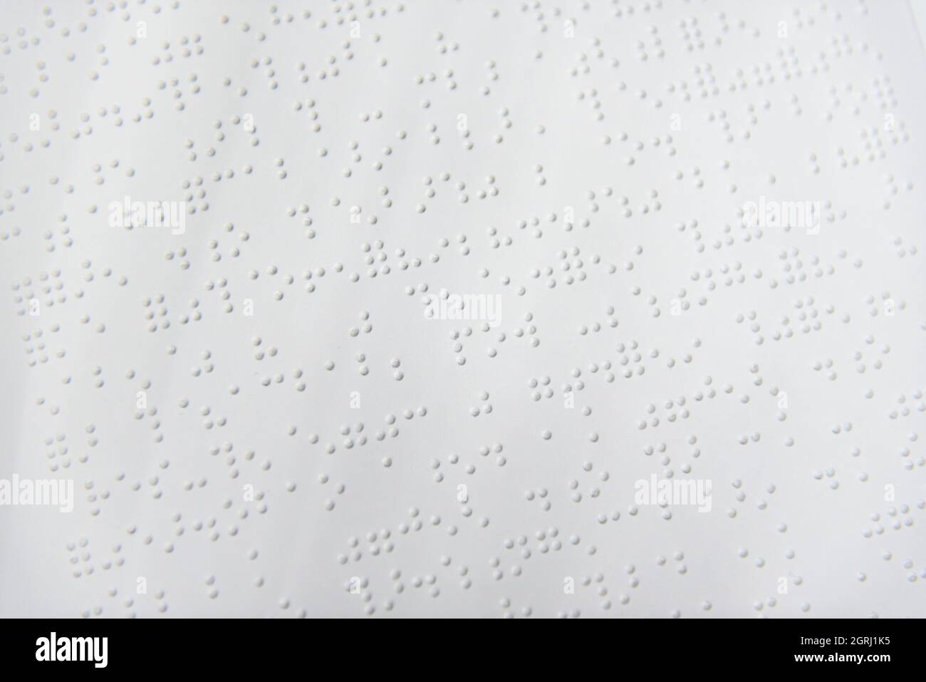 A fragment of text in Louis Braille printed on a standard sheet of ...