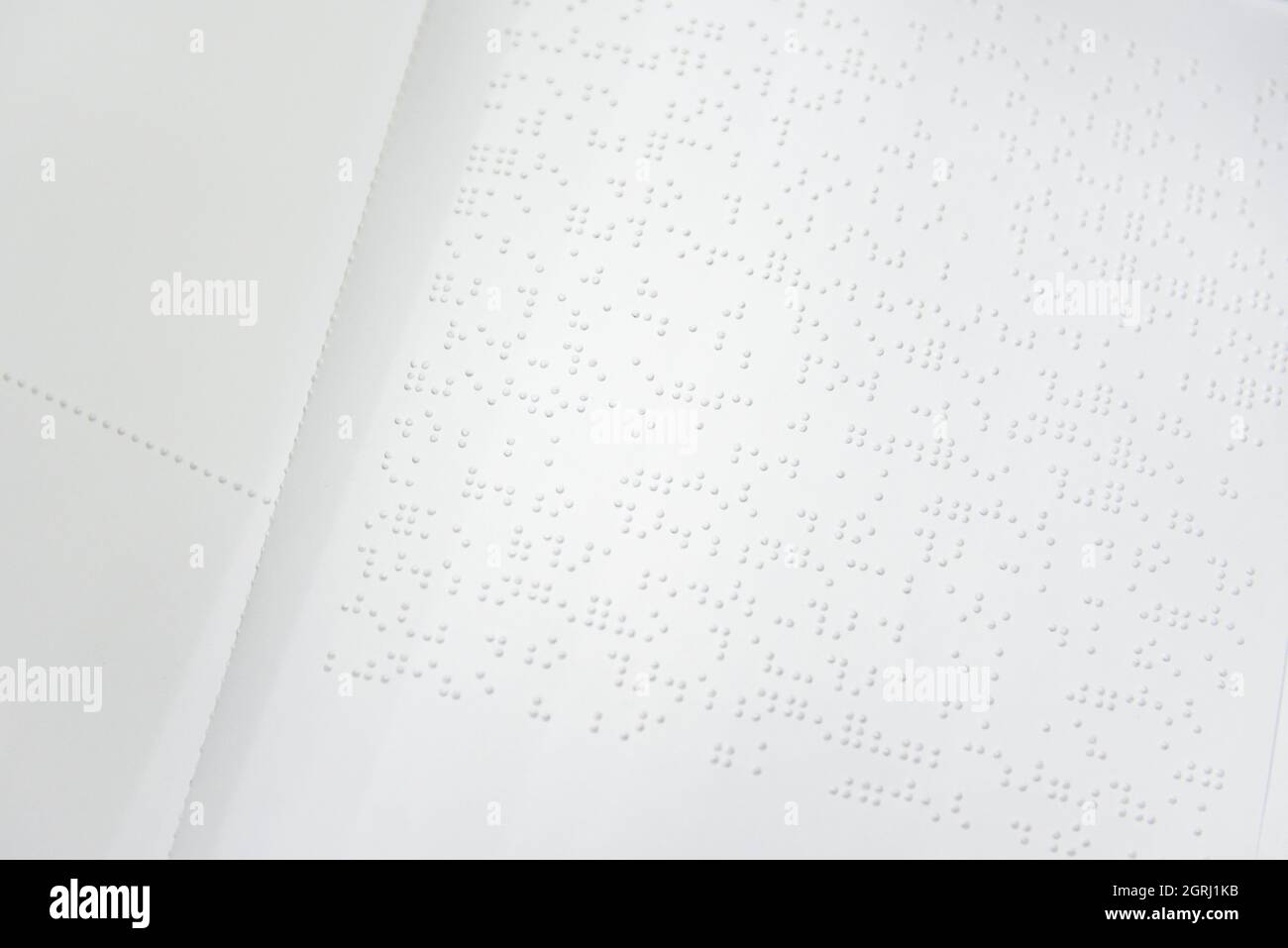 A fragment of text in Louis Braille printed on a standard sheet of ...