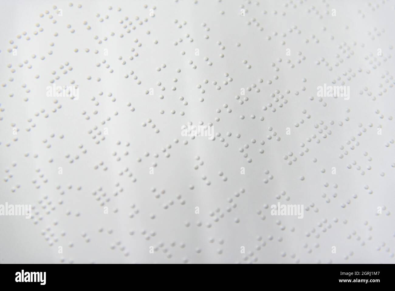 A fragment of text in Louis Braille printed on a standard sheet of ...