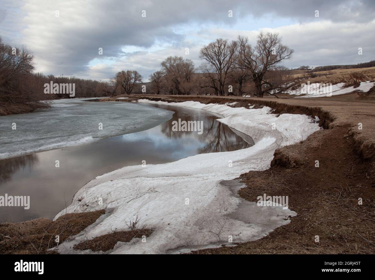 River in early spring with the remains of snow on the banks Stock Photo ...