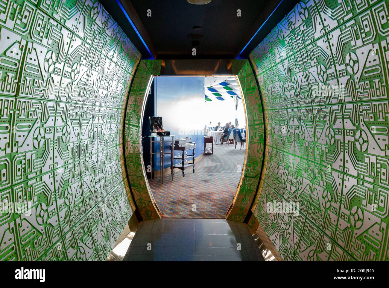 Fisheye view of a corridor with green and white mosaic walls leading to ...