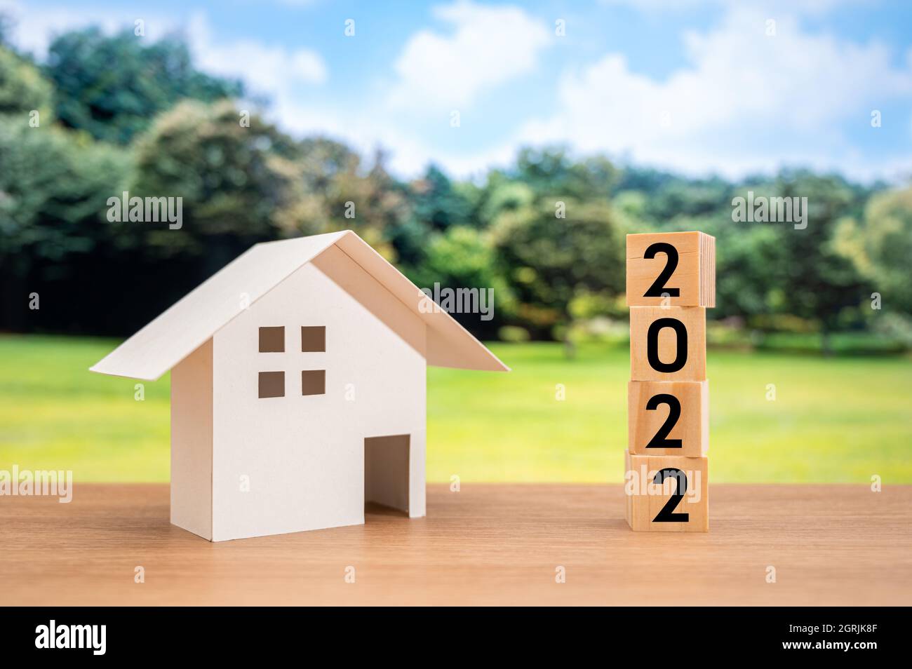 A white model house, and wooden cube with 2022 text Stock Photo - Alamy