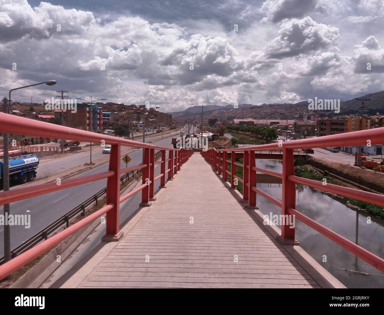 Pedestrian bridge over a river in a town Stock Photo - Alamy