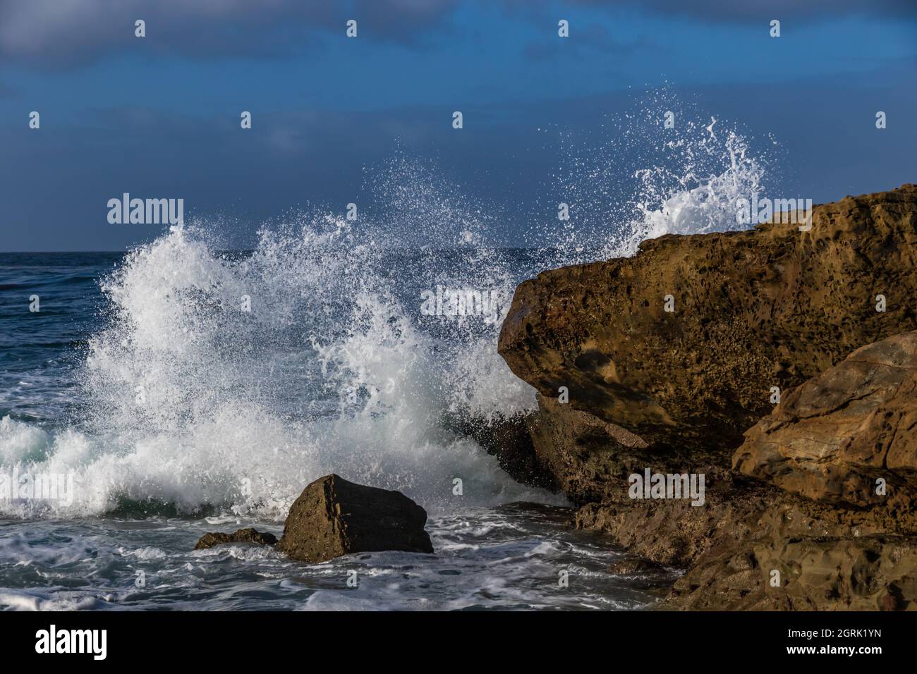 Wave breaking on rock in Laguna Beach, California. Water spilling over ...
