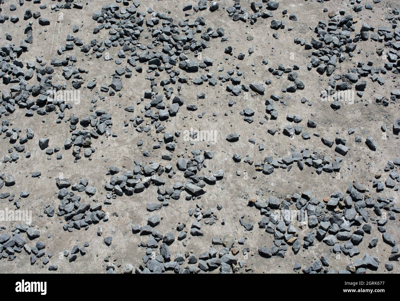 Top view shot of a textured floor covered in small sharp rock pebbles ...