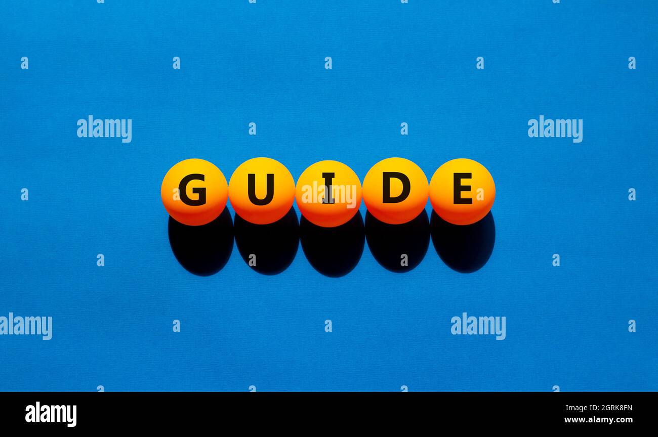 Guide and support symbol. The concept word 'guide' on orange table ...