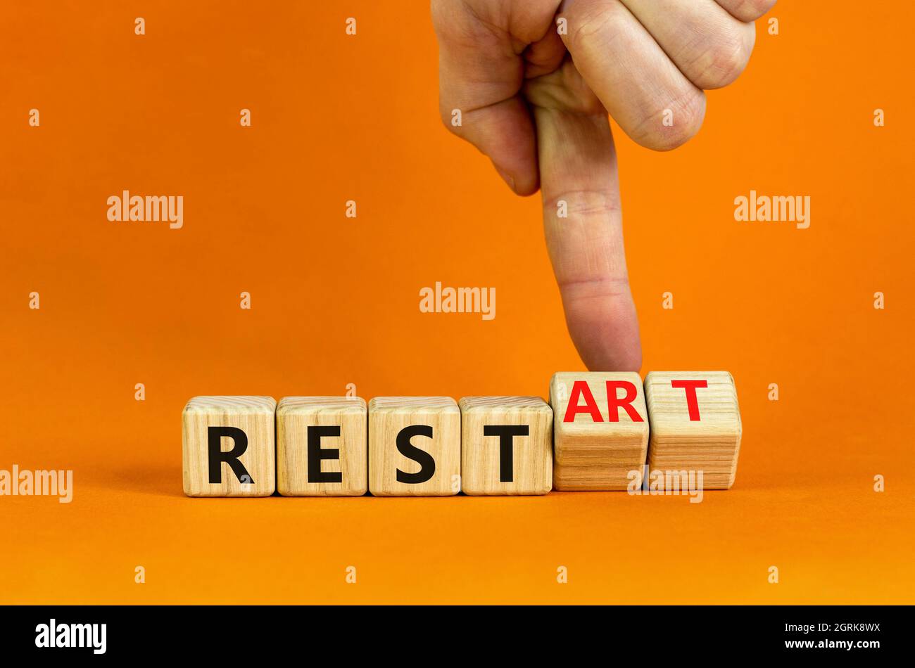 Rest and restart symbol. Businessman turns wooden cubes and changes the ...