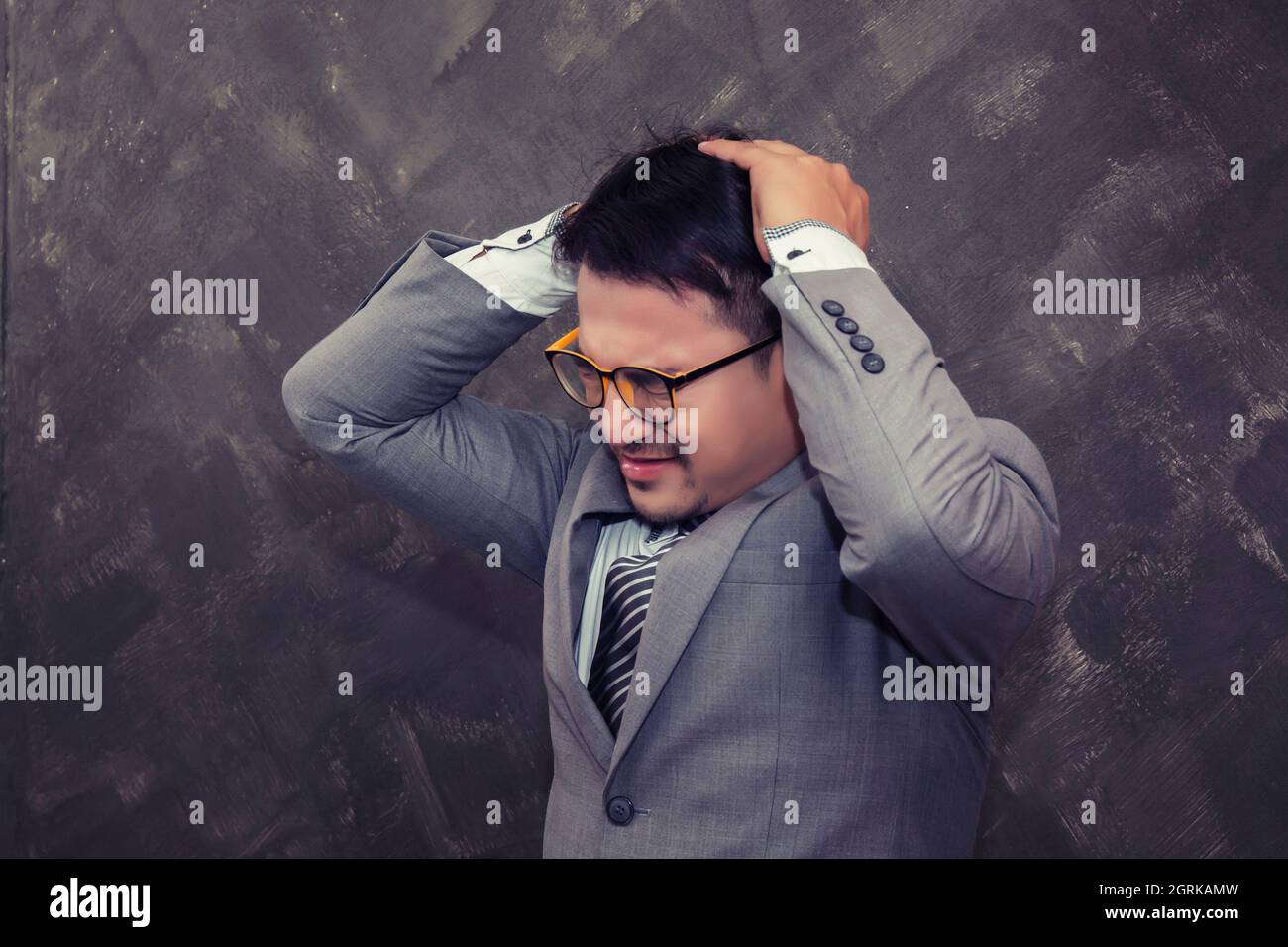 Frustrated Businessman Standing Against Wall Stock Photo - Alamy