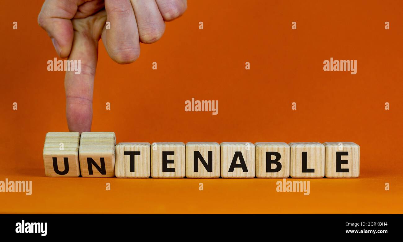 Tenable or untenable symbol. Businessman turns cubes and changes the ...