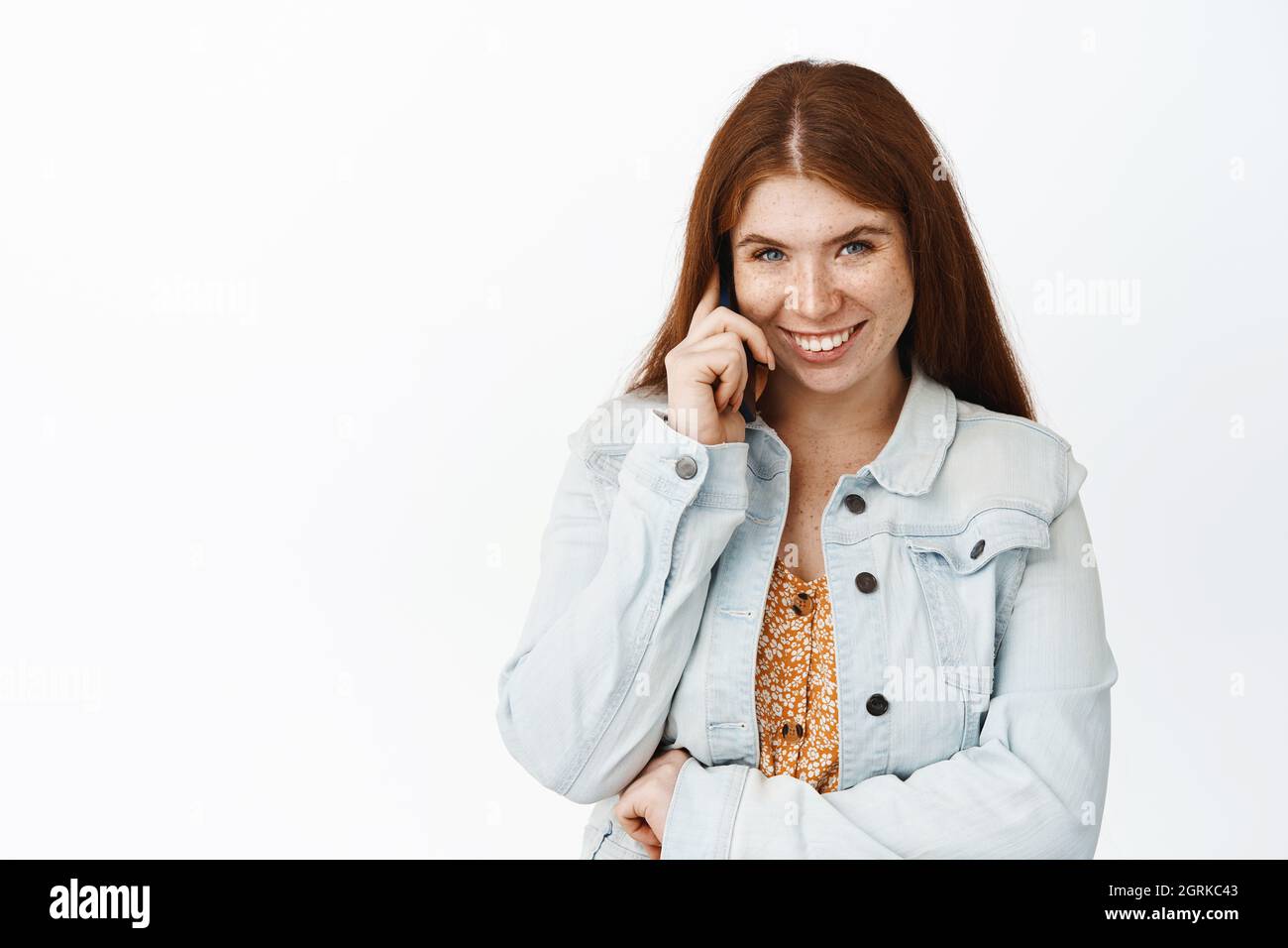 Portrait of cute young woman talking on mobile phone with happy face ...