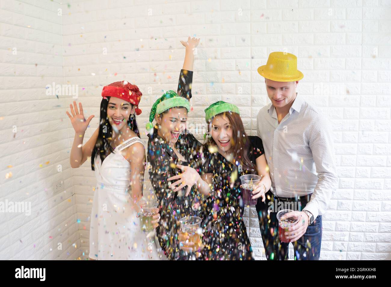 Four young friends against brick wall hi-res stock photography and ...