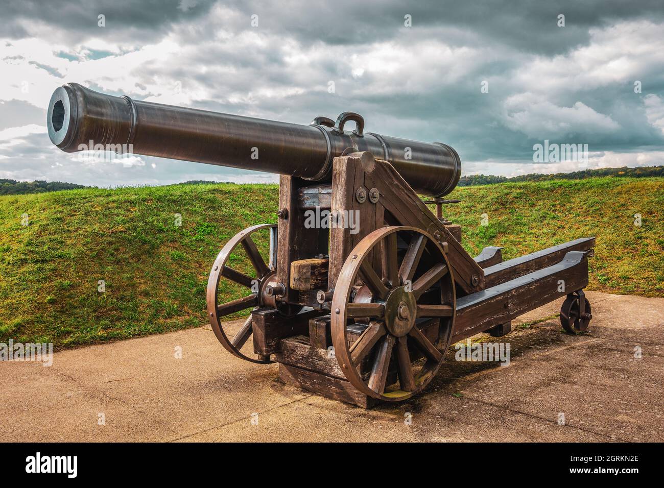 Old historical cannon, storm clouds in the background Stock Photo - Alamy