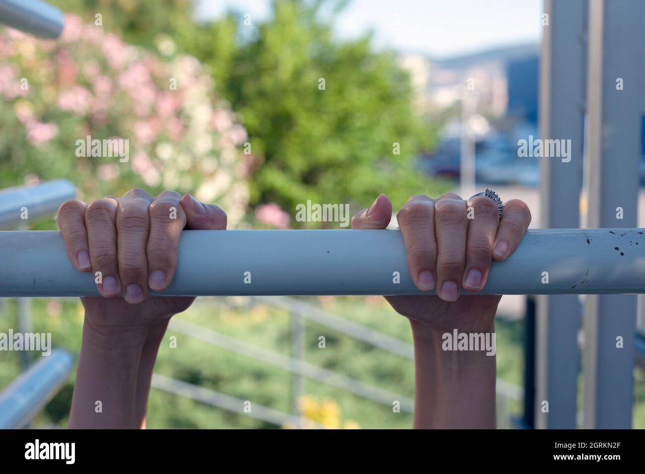 Clinging, grasping, sagging, freedom, two hand Stock Photo - Alamy