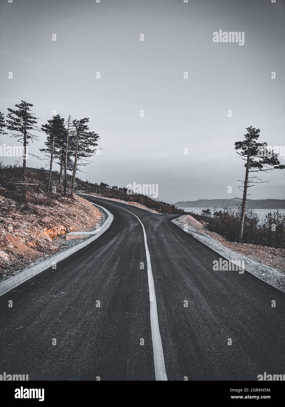 Branching road on a gloomy day Stock Photo - Alamy