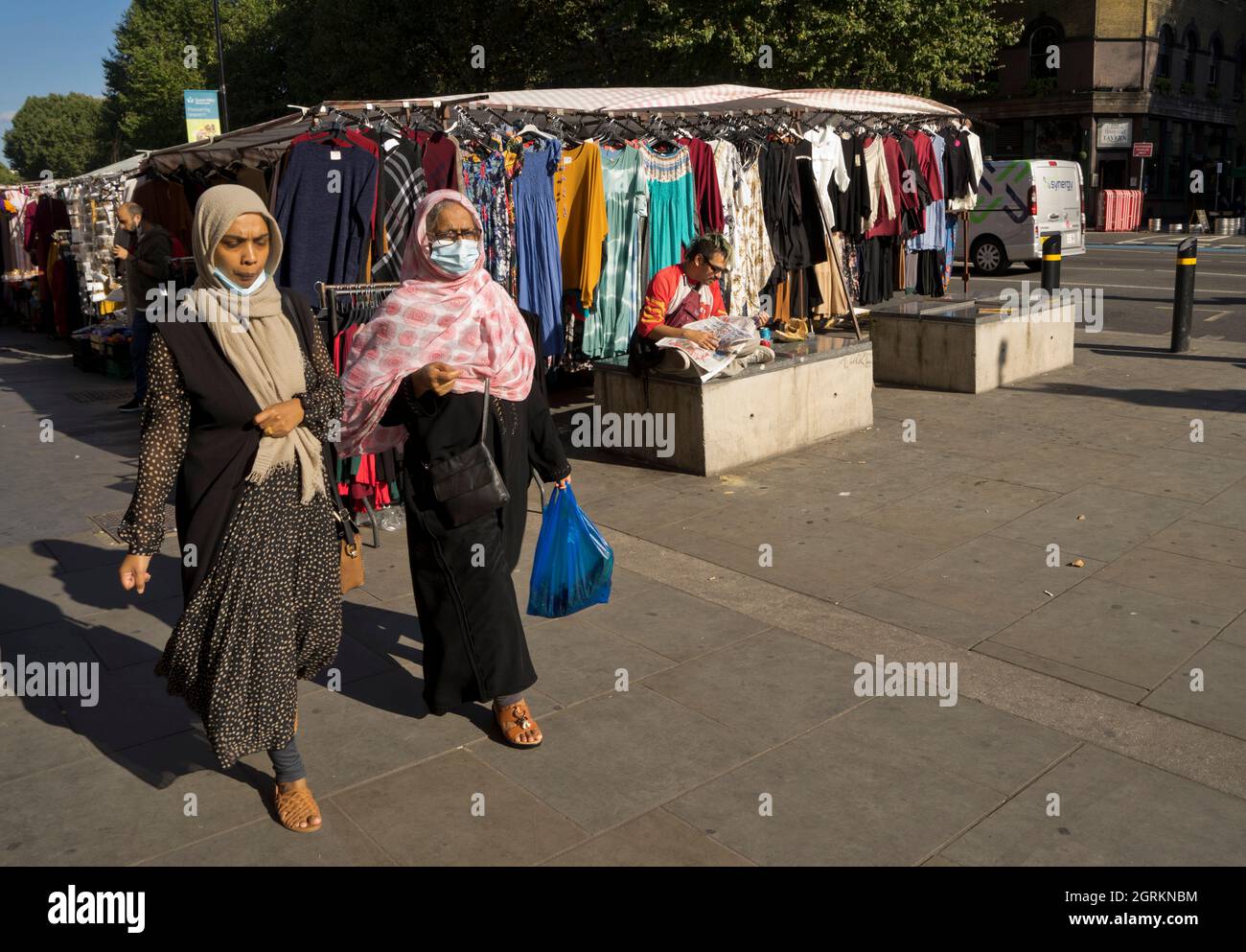 Local Muslim women shopping at stalls with fruit, food and textiles at ...