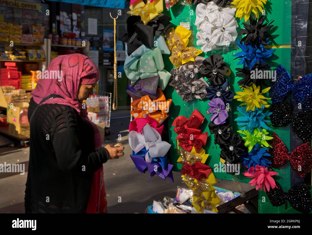 Local Muslim women shopping at stalls with fruit, food and textiles at ...