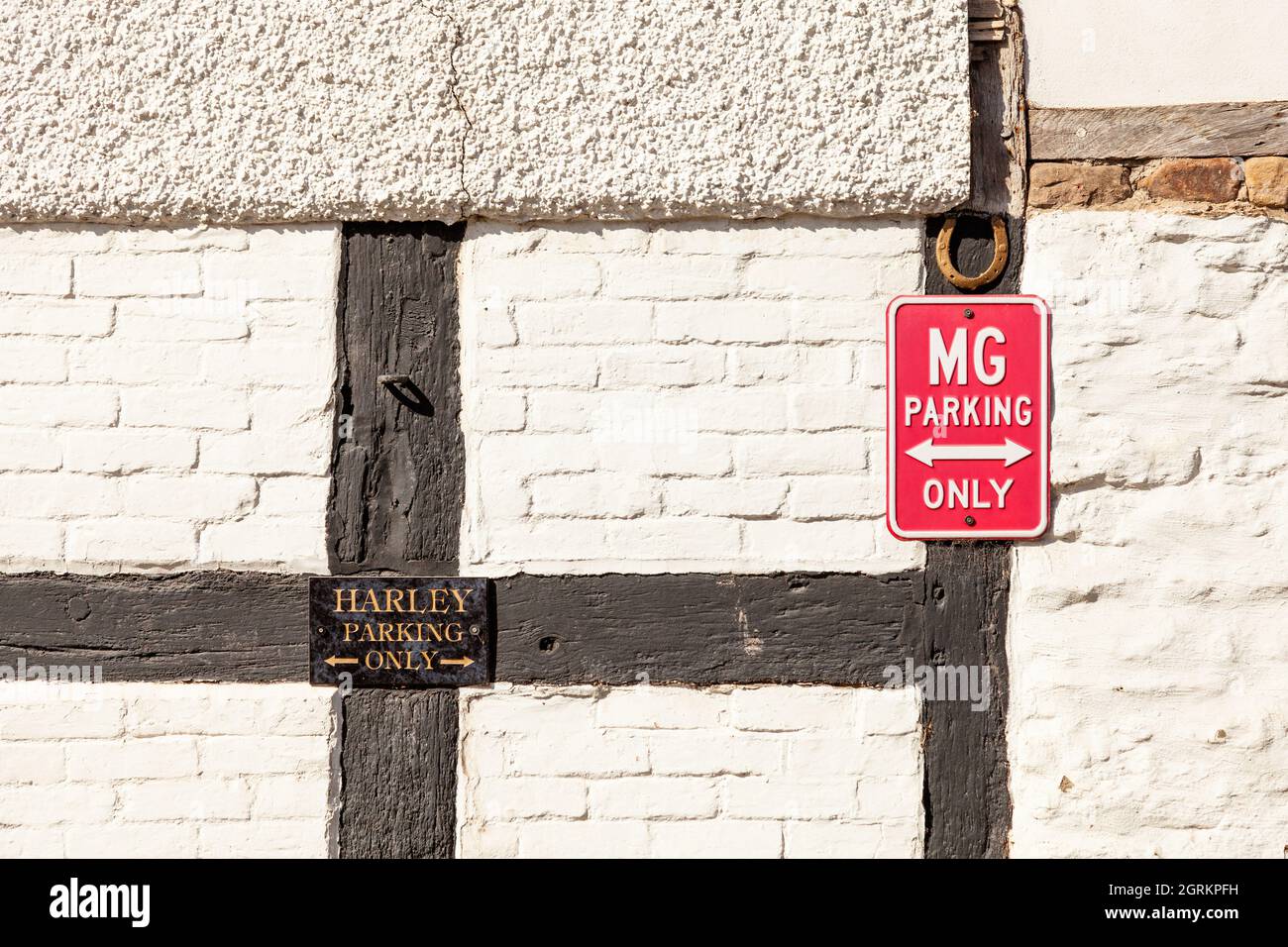 Harley only and MG only parking signs on timber beams of black and ...