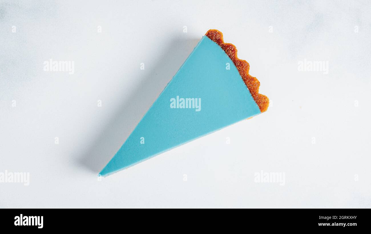 Top view of a triangular piece of a fresh tasty vegan cake isolated on ...