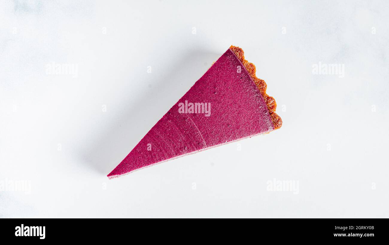 Top view of a triangular piece of a fresh tasty vegan cake isolated on ...