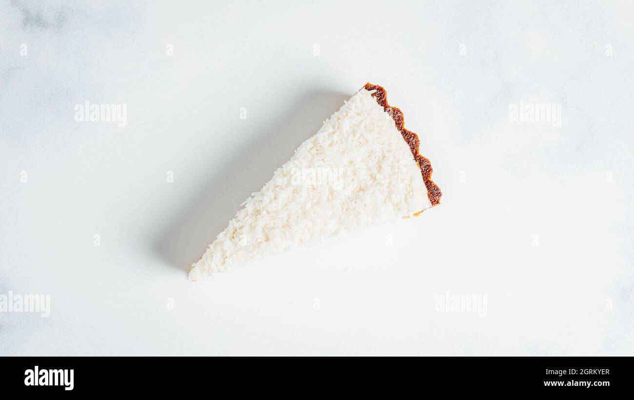 Top view of a triangular piece of a fresh tasty vegan cake isolated on ...