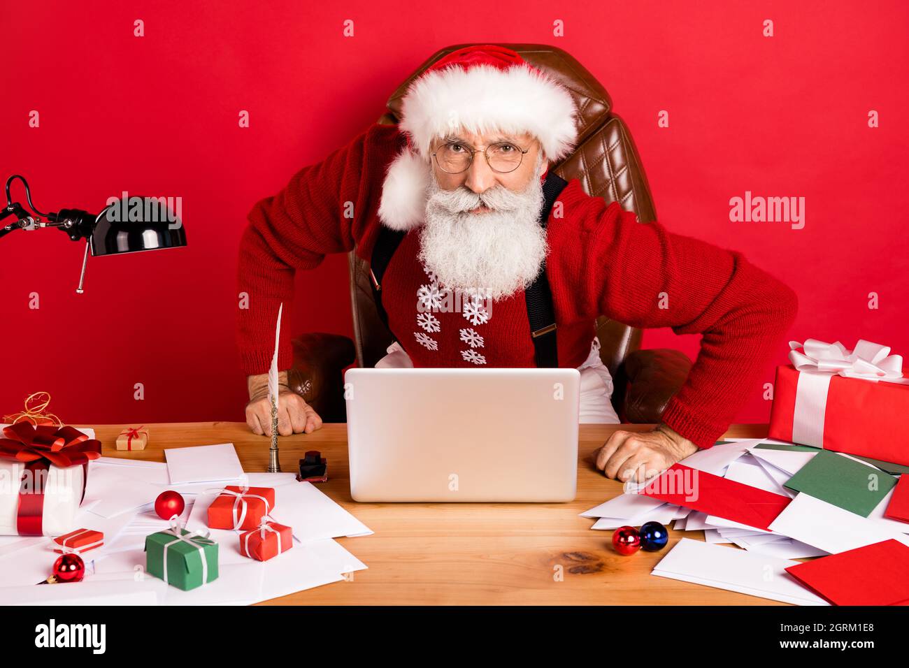 Photo of santa claus unhappy negative angry problem sit table computer ...