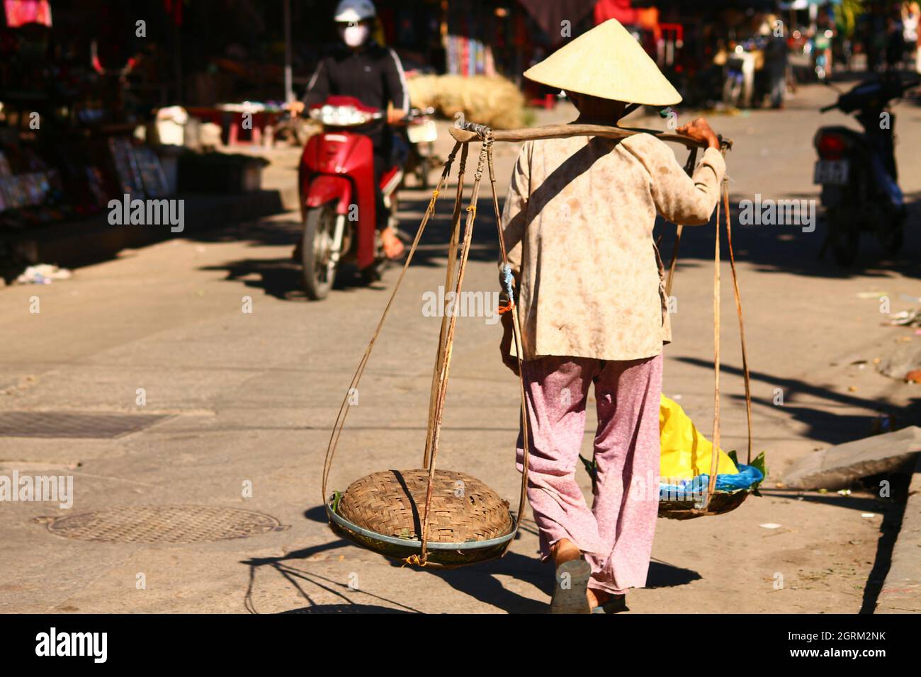 One carrying shoulder pole hi-res stock photography and images - Alamy