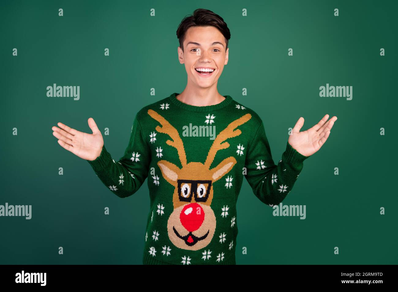 Photo of cheerful funny nice guy open palms toothy smile wear deer ...