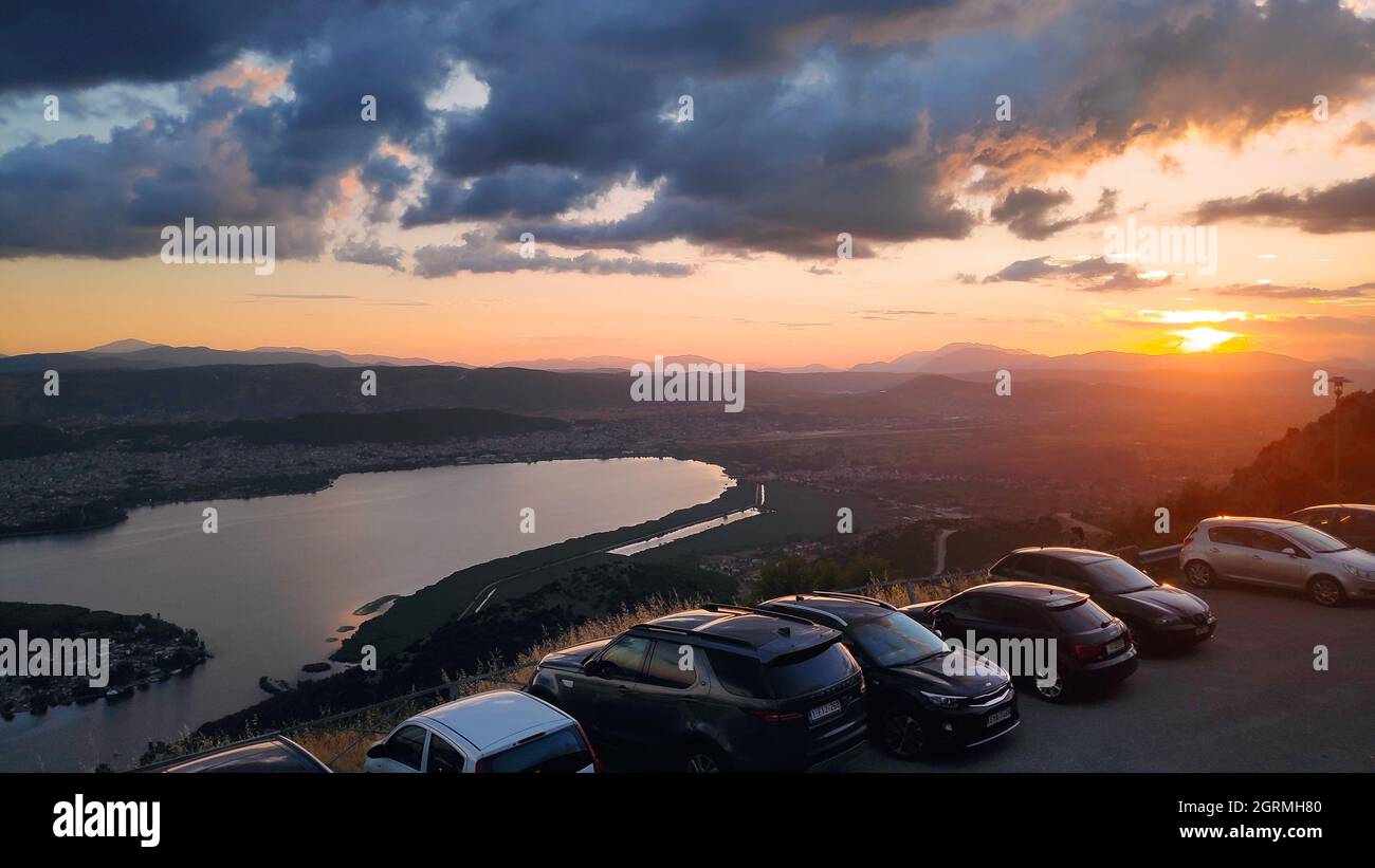 Scenic view of cars parked on top of a hill with the mesmerizing sunset ...