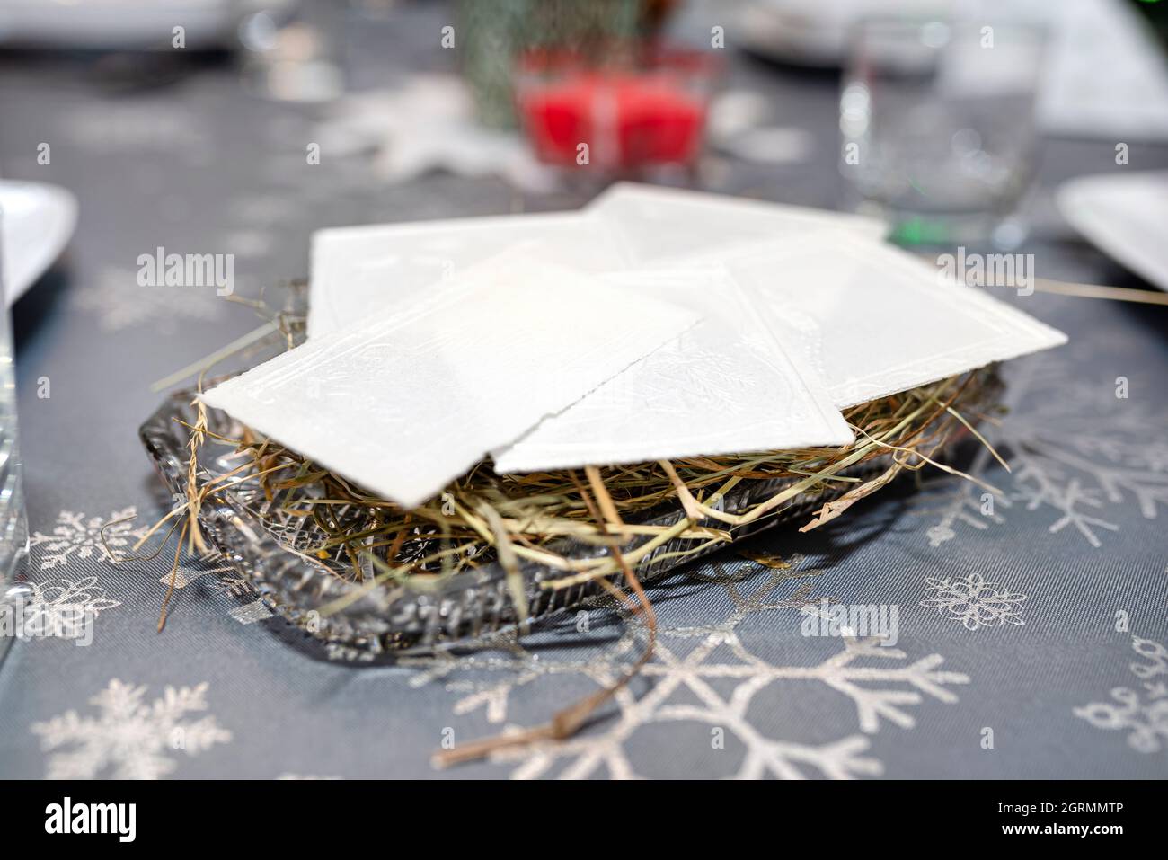 Wafer lying on the hay on the Christmas table during Christmas Eve in ...
