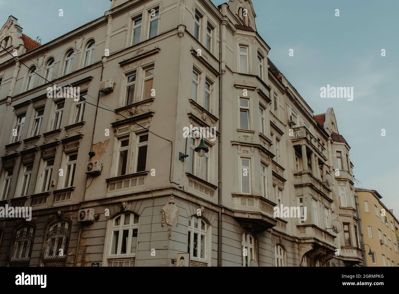 Old white building with windows and lamps Stock Photo - Alamy