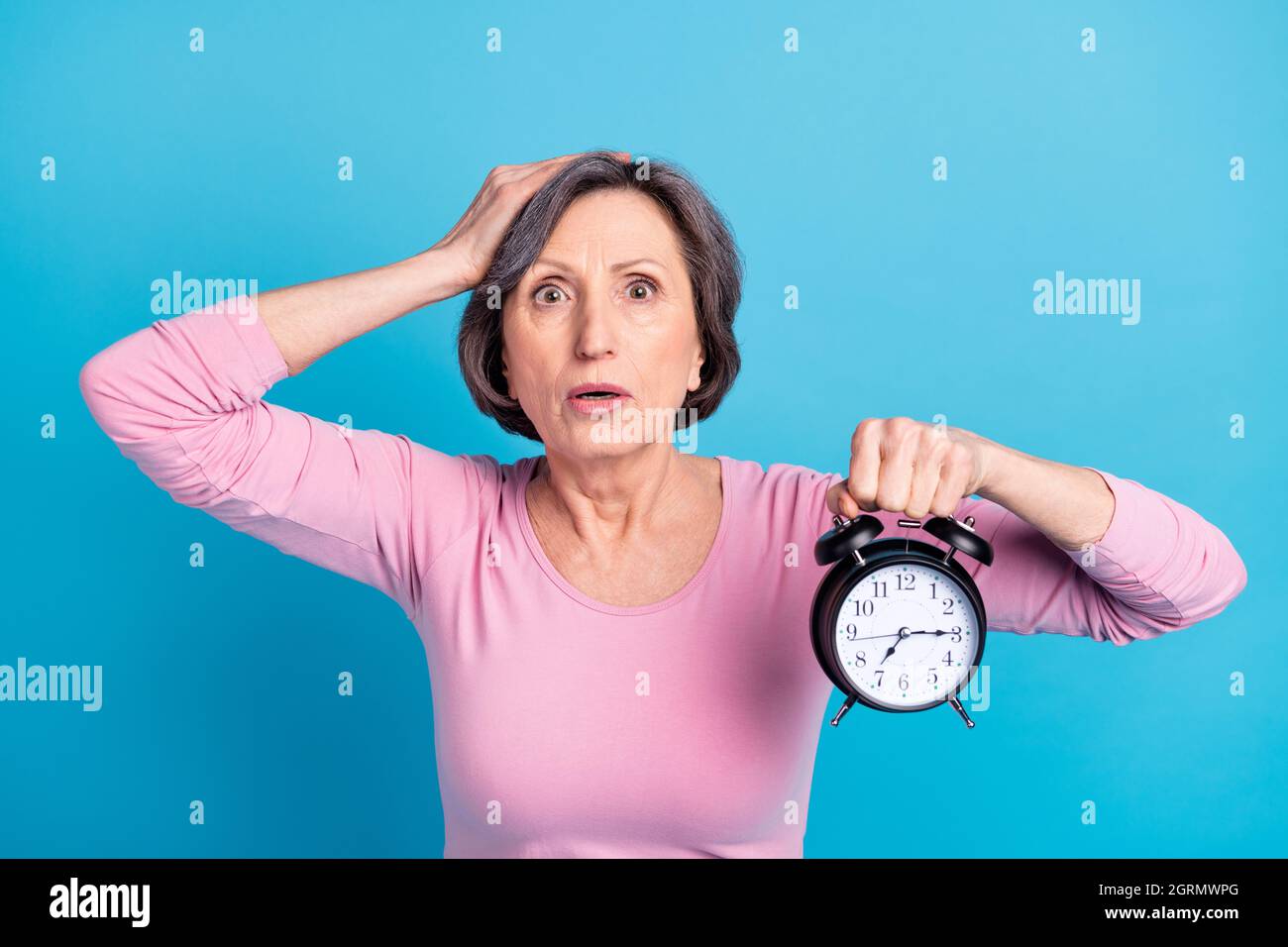 Photo of shocked amazed surprised mature woman hold clock missed alarm ...