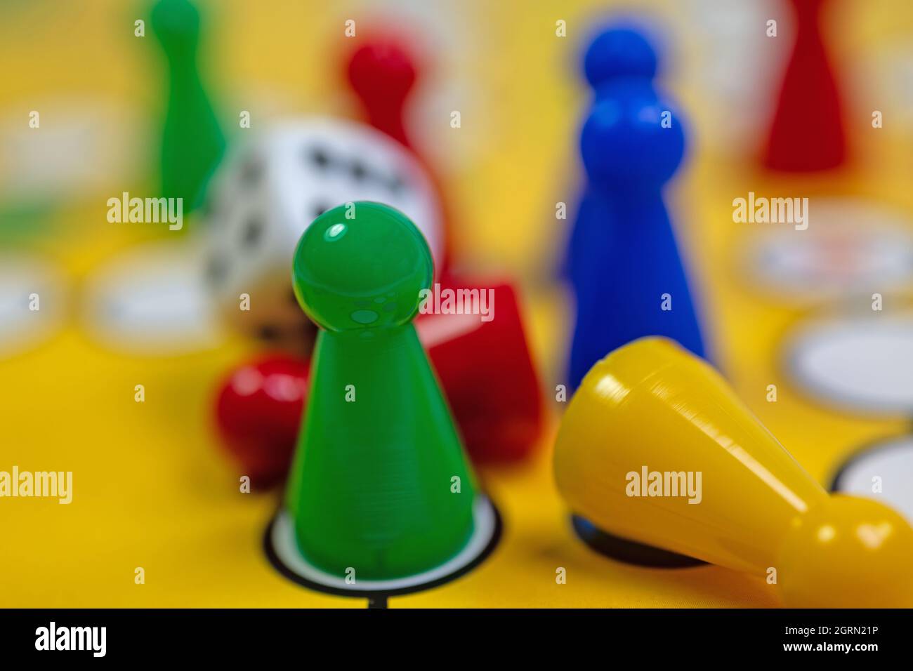 Colorful playing figures and dice in a close-up Stock Photo - Alamy