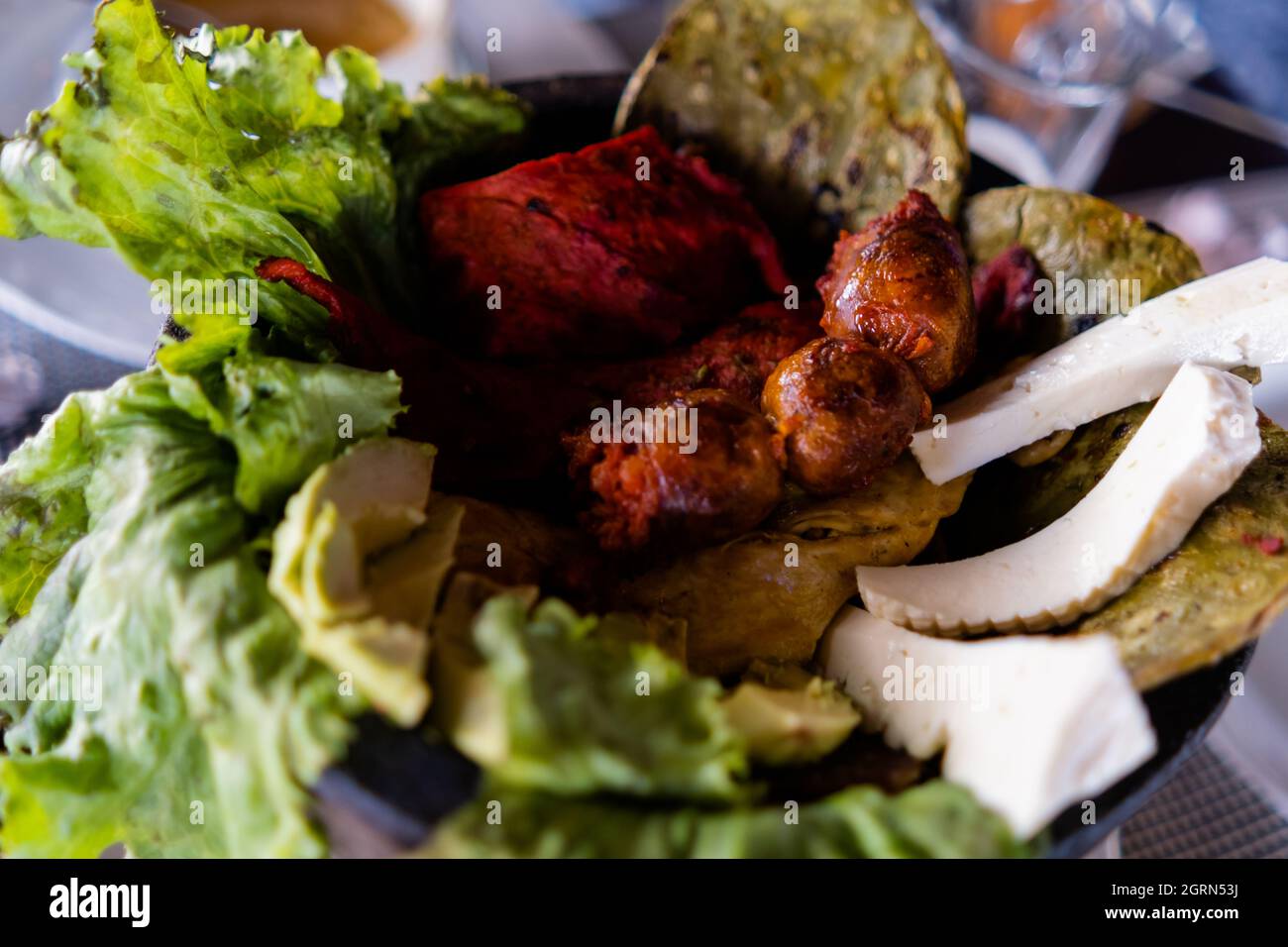 White cheese slices, lettuce, Mexican chorizo, and roasted nopales meal ...