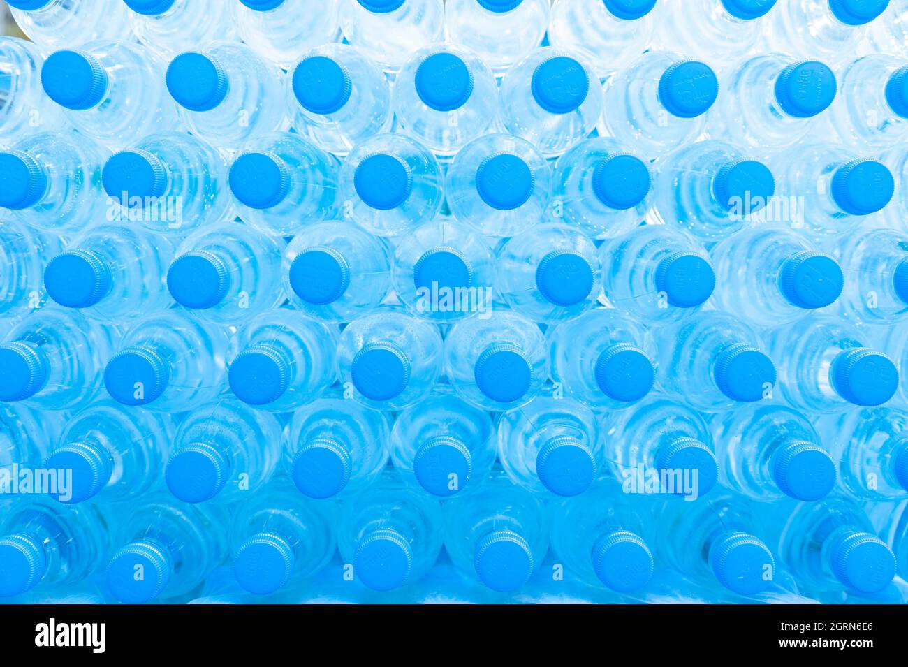 Plastic bottles and blue caps Stock Photo - Alamy