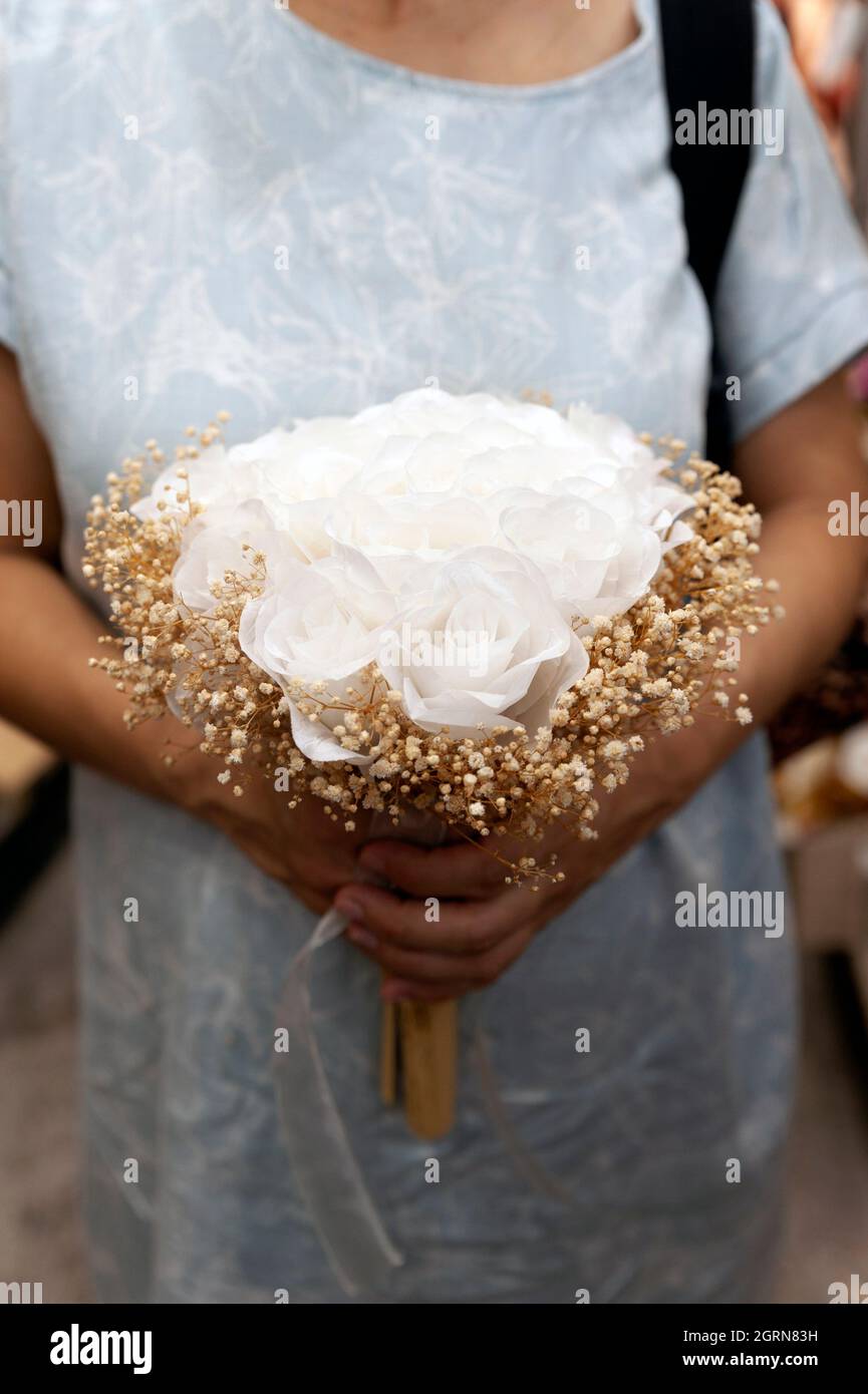 Lady bride holding flower Stock Photo - Alamy
