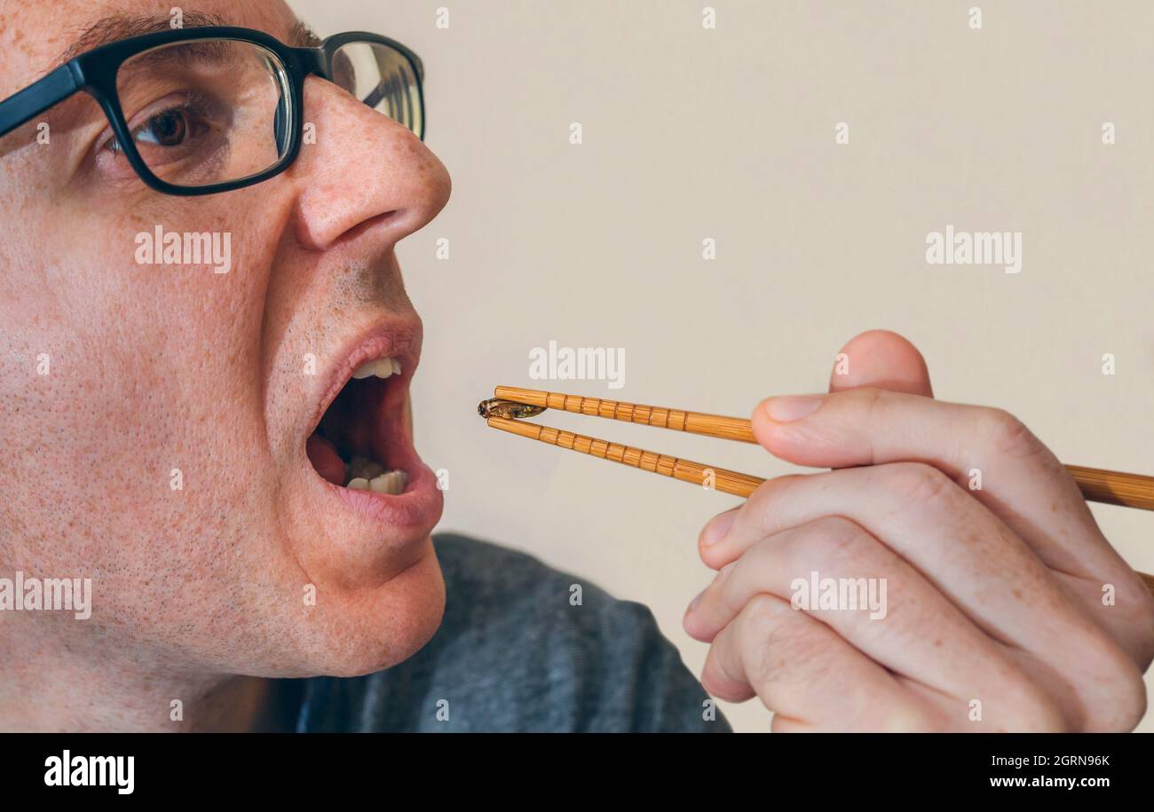 Man eating insect hi-res stock photography and images - Alamy