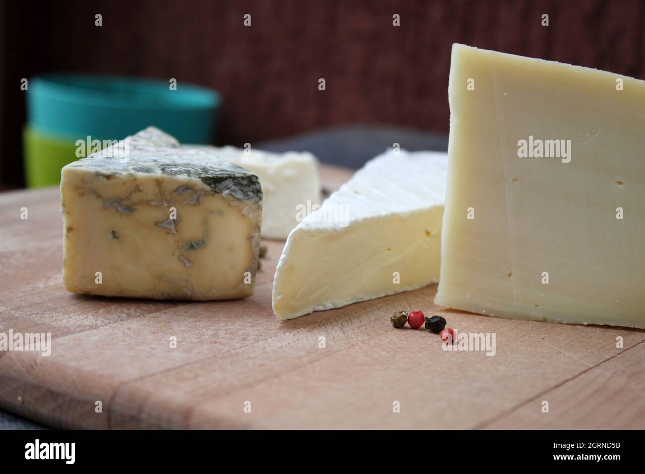 Different types of cheese on wooden desk Stock Photo - Alamy