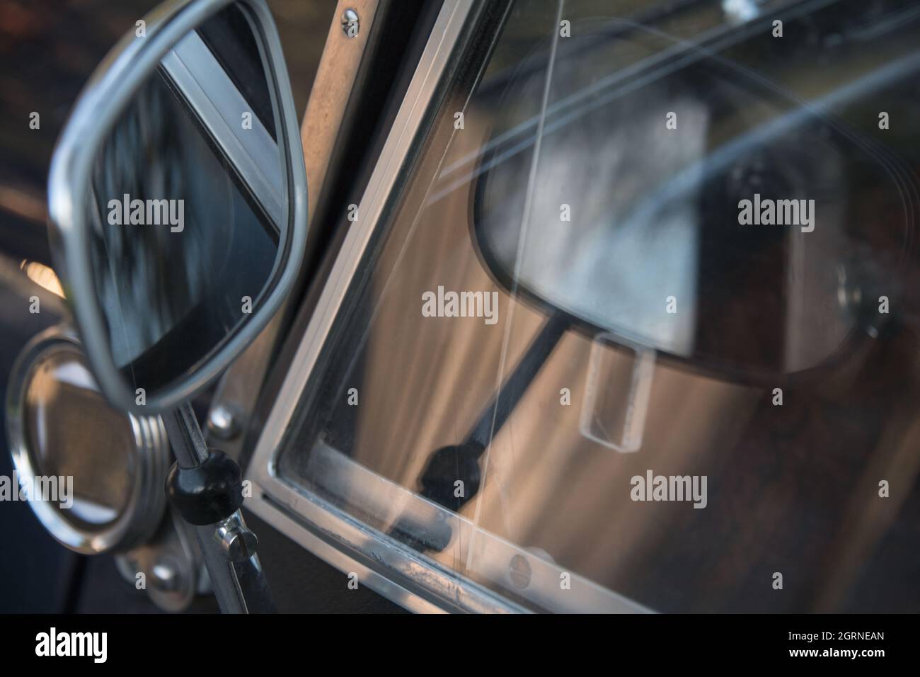 Close up of side mirror and side window of classic car with reflection ...