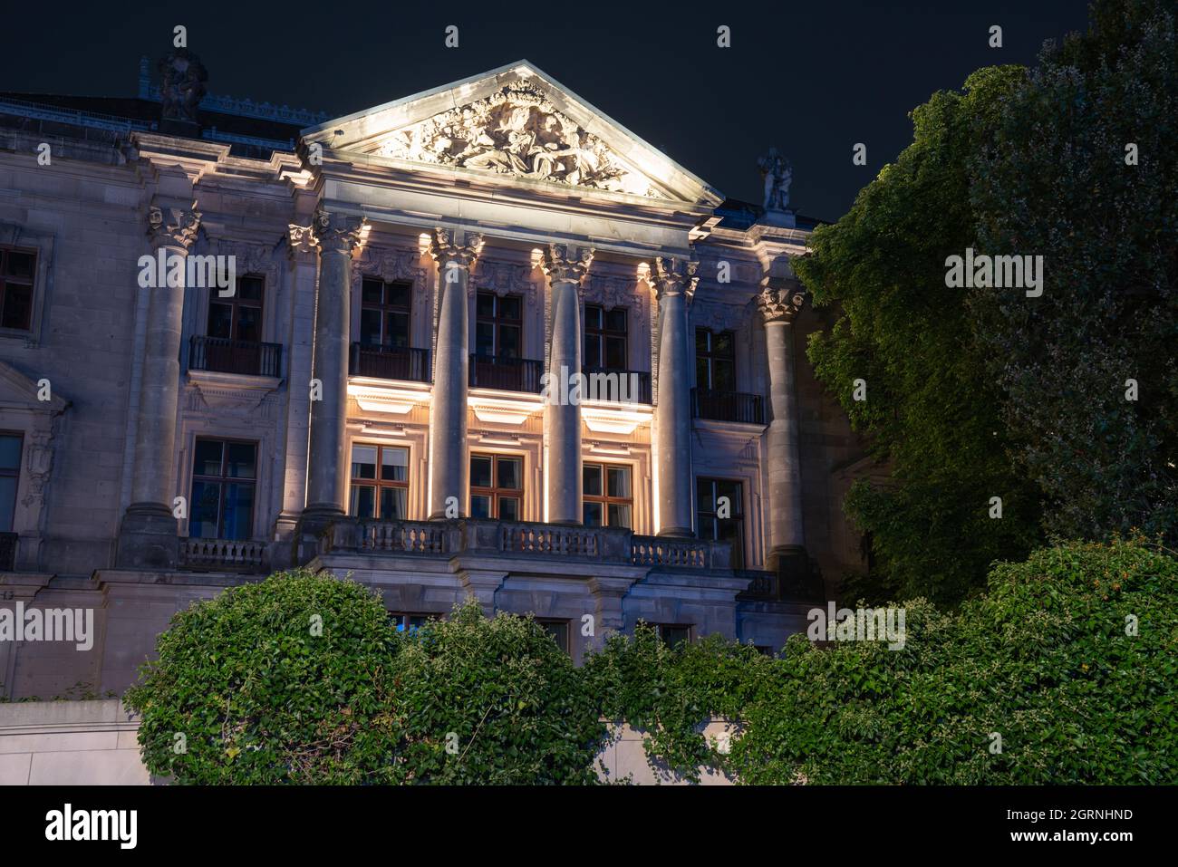 Classical ornate building facade with ornate pediment above six pillars ...