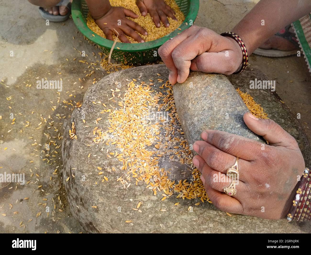 Woman grinding rice hi-res stock photography and images - Alamy