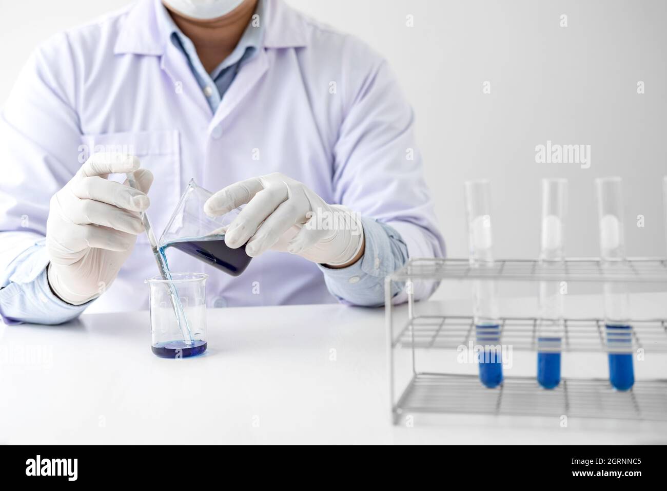 Scientist mixing chemicals hi-res stock photography and images - Alamy