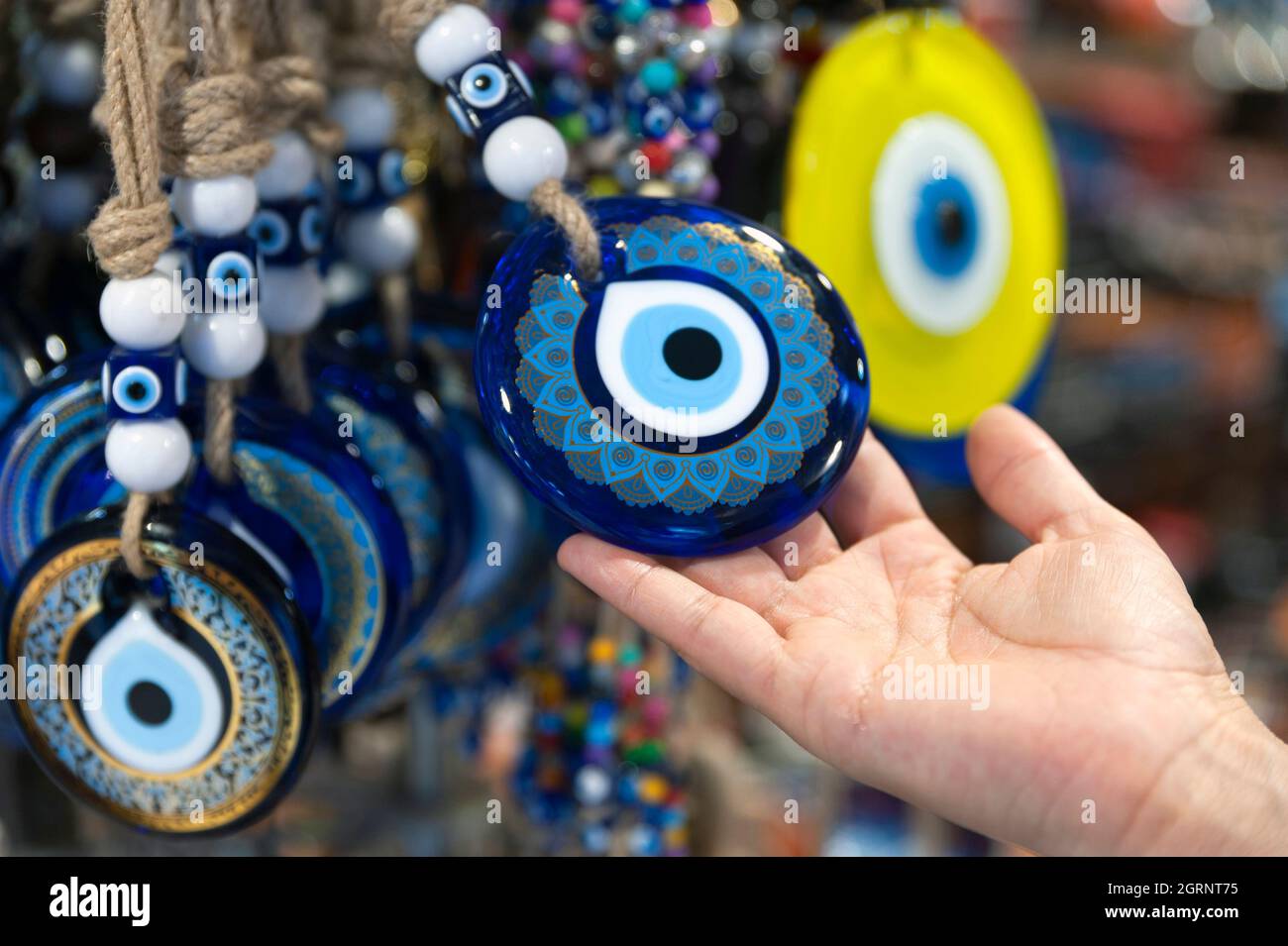 Big evil eye bead in female hand stock photo Stock Photo - Alamy