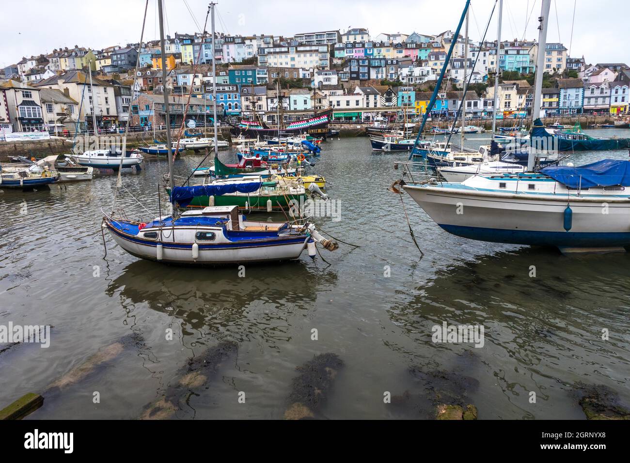 Boats aground at low water in Brixham Harbour South Devon England Stock ...