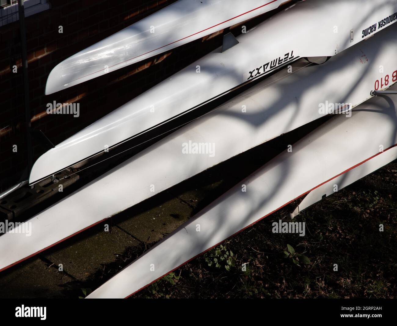 Close up of a row of white rowing skulls hulls stored upside-down white ...