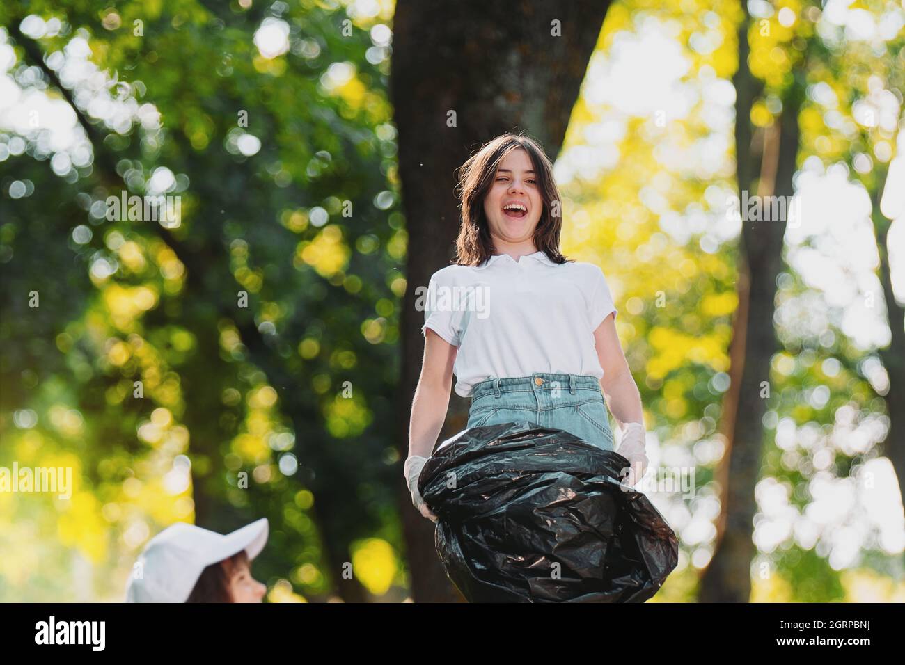 Photo from above of a young smiling wide happy girl volunteer in ...