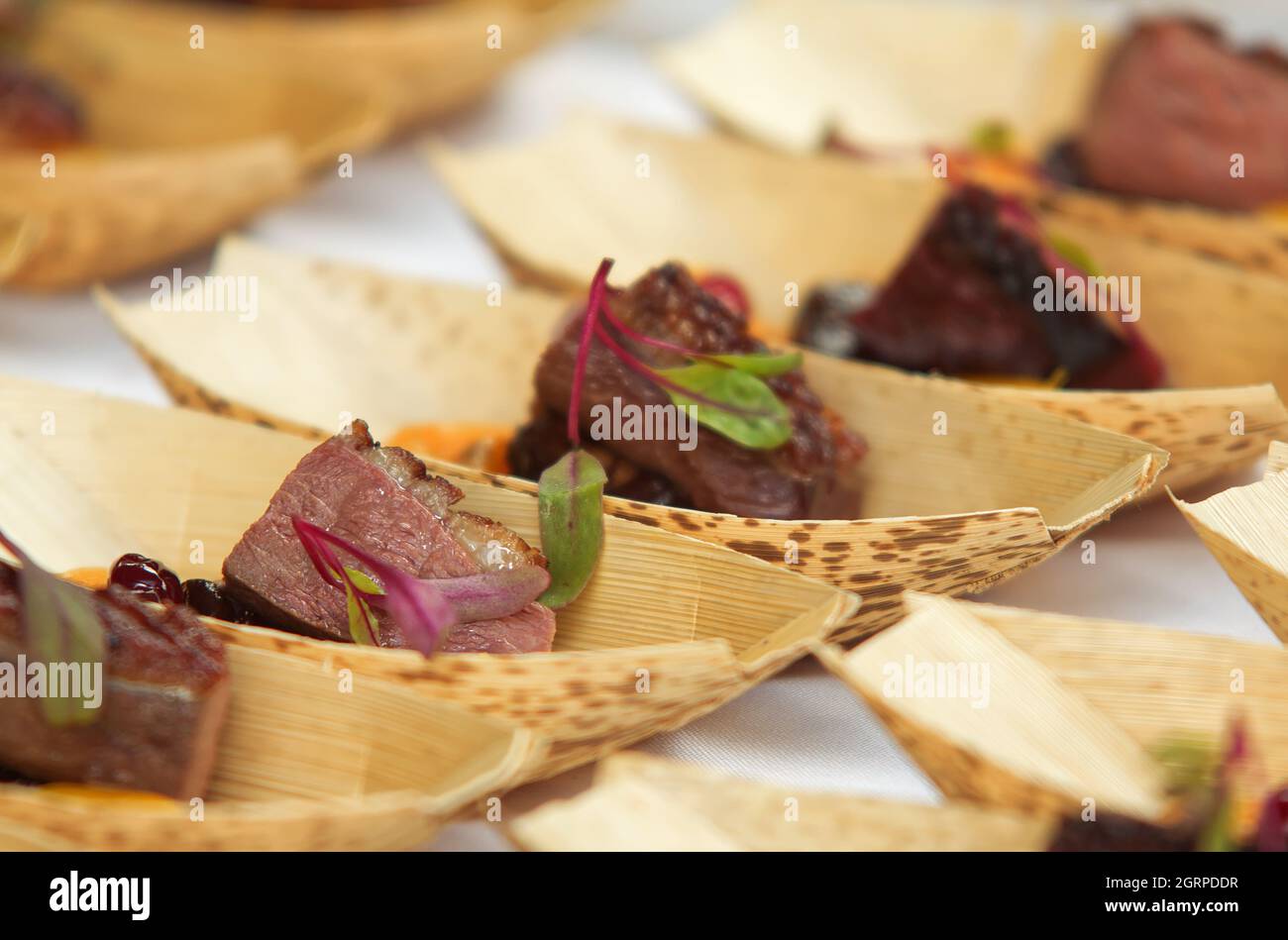 Cooking demonstration, table with food portions on display Stock Photo ...