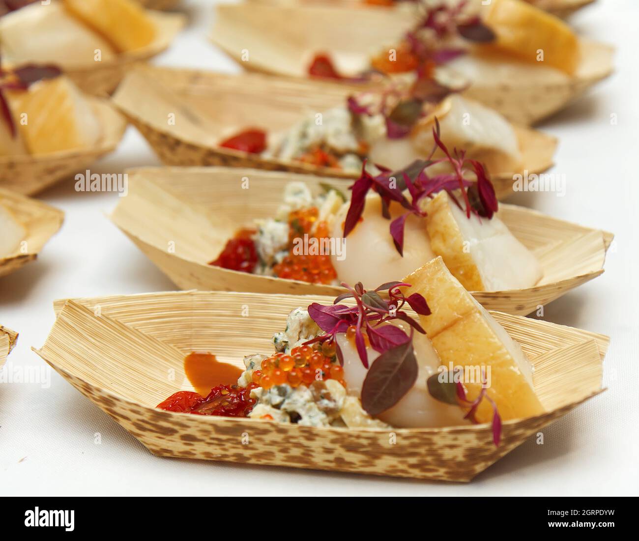 Cooking demonstration, table with food portions on display Stock Photo ...